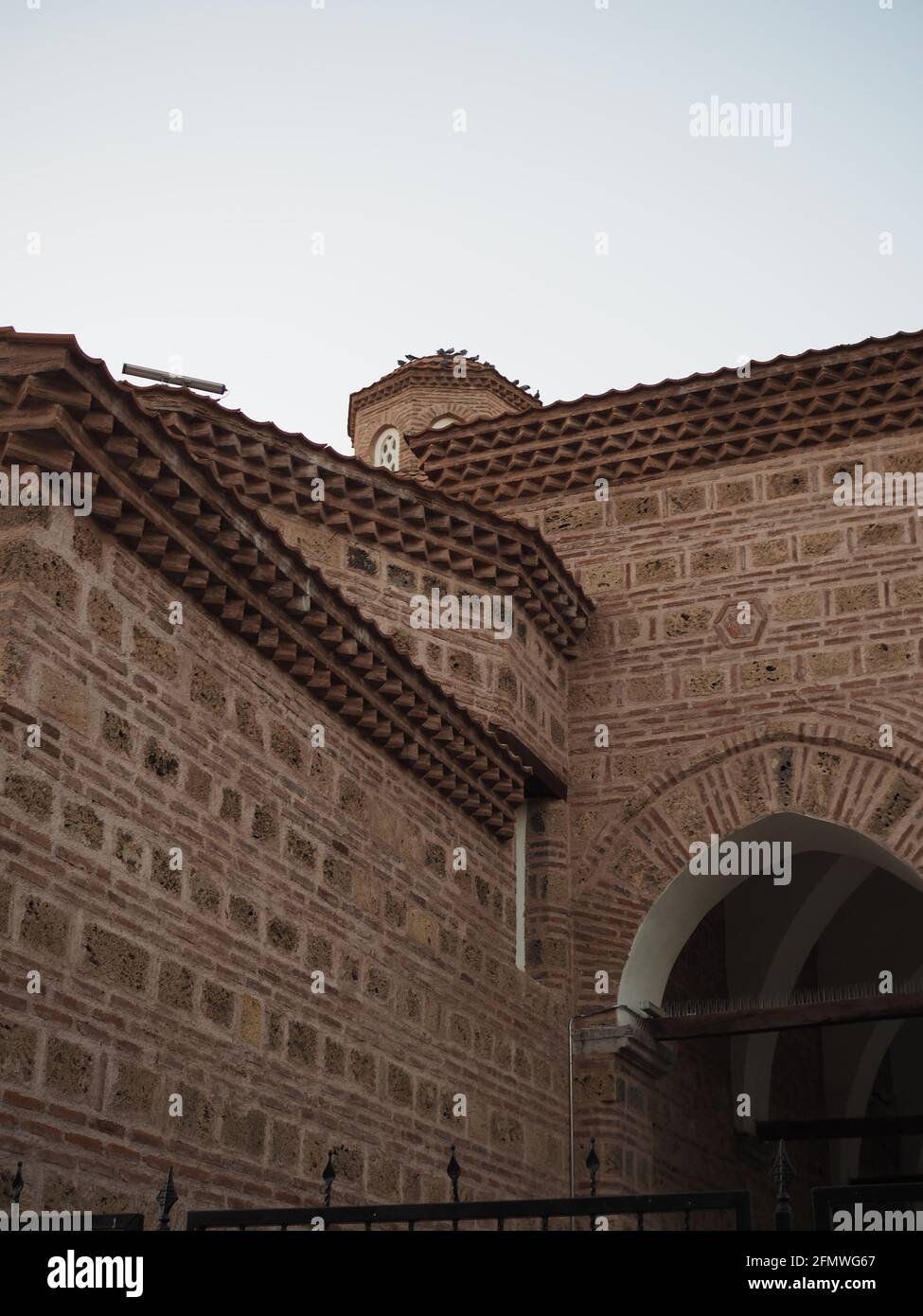 A group of birds on the tops of different layers building made by brick ...