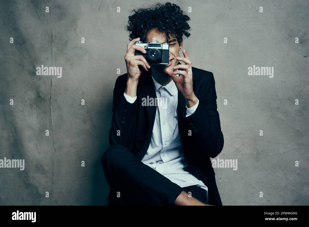 handsome man in studio with camera fabric background classic suit model ...