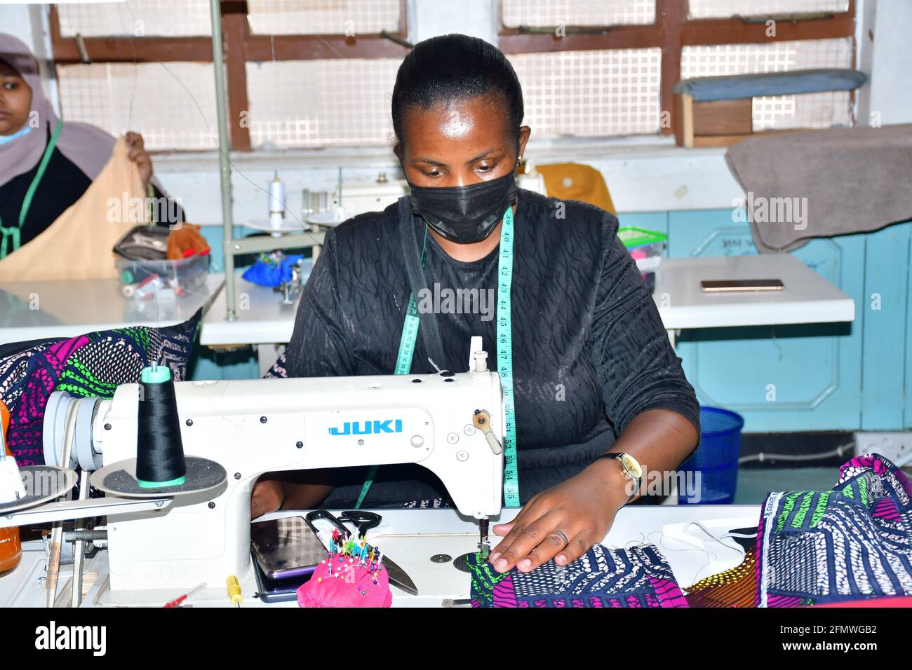 African seamstress sews clothes. Workplace of tailor Stock Photo - Alamy