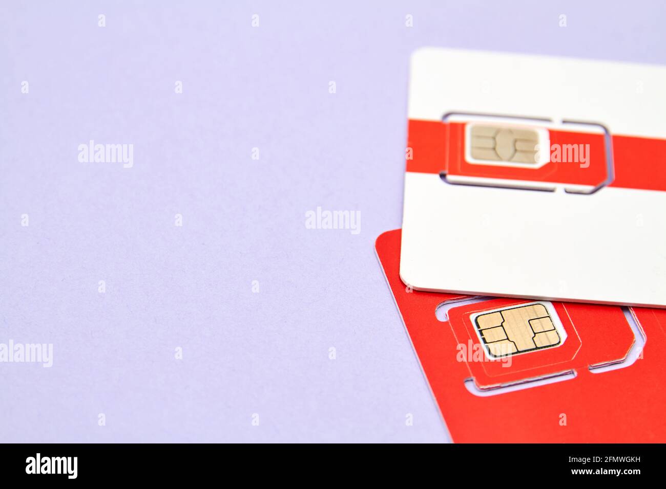 Sim cards for mobile phones on purple background Stock Photo - Alamy