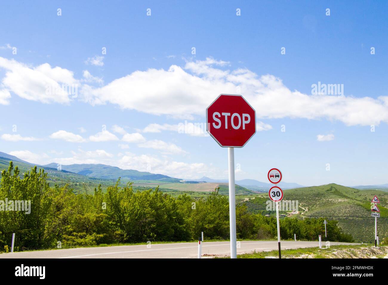 Stop sign on the road, red stop sing on the highway in Didgori, Georgia ...