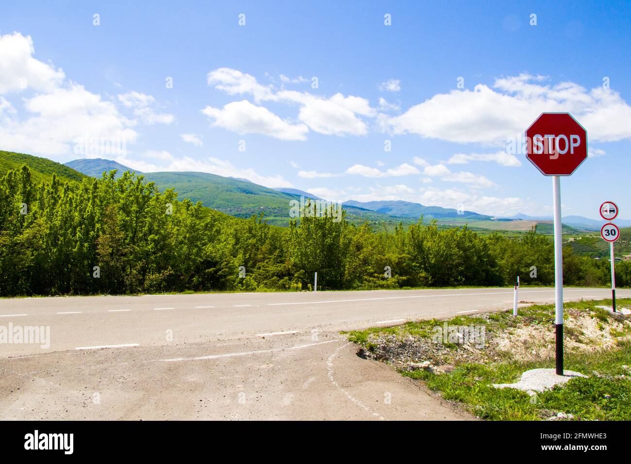 Stop sign on the road, red stop sing on the highway in Didgori, Georgia ...