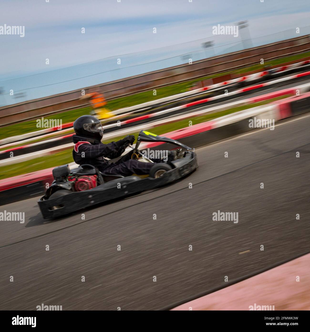 A panning shot of a racing kart as it circuits a track Stock Photo - Alamy
