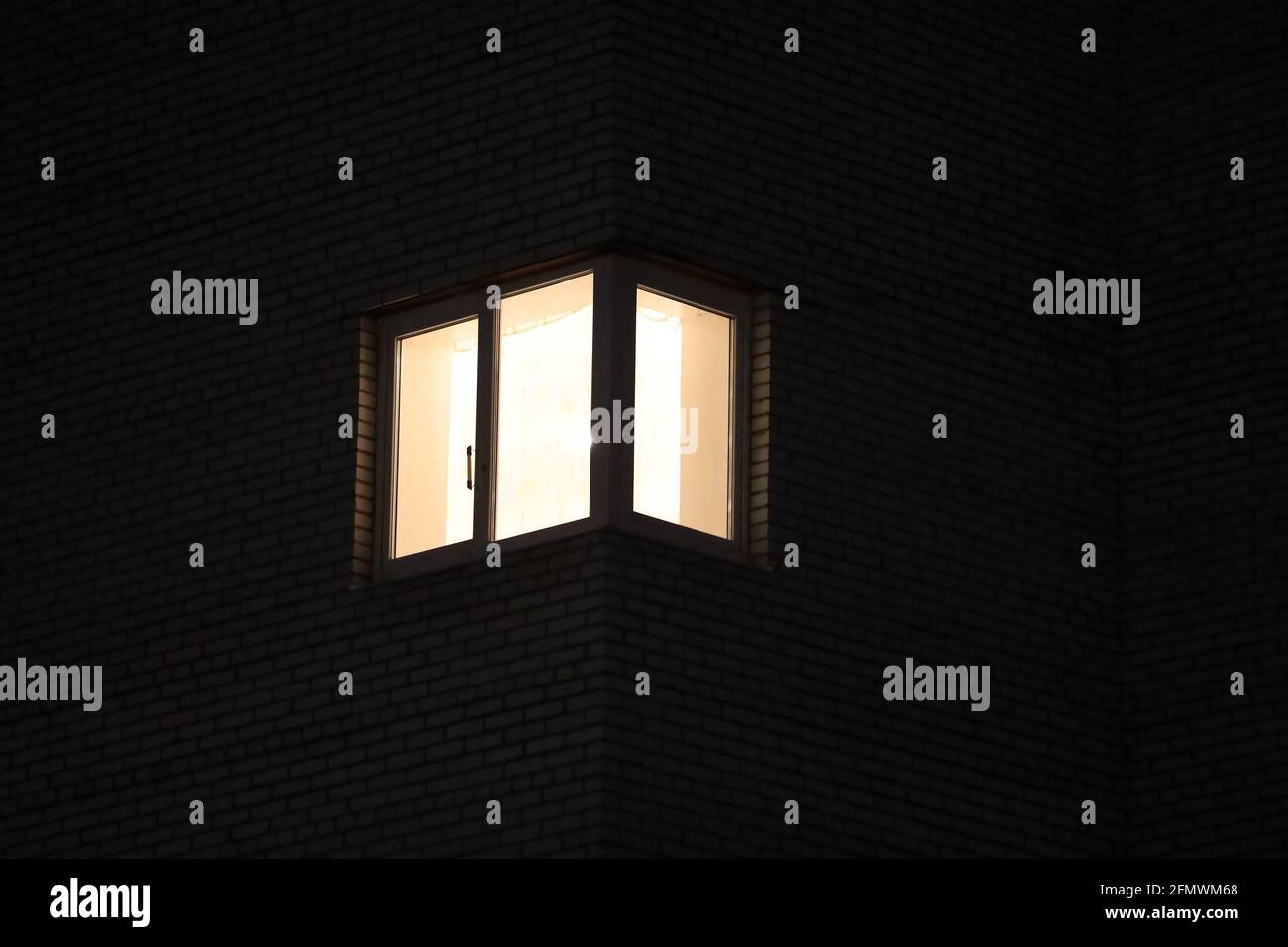 Windows glow in an apartment building at night. High quality photo ...