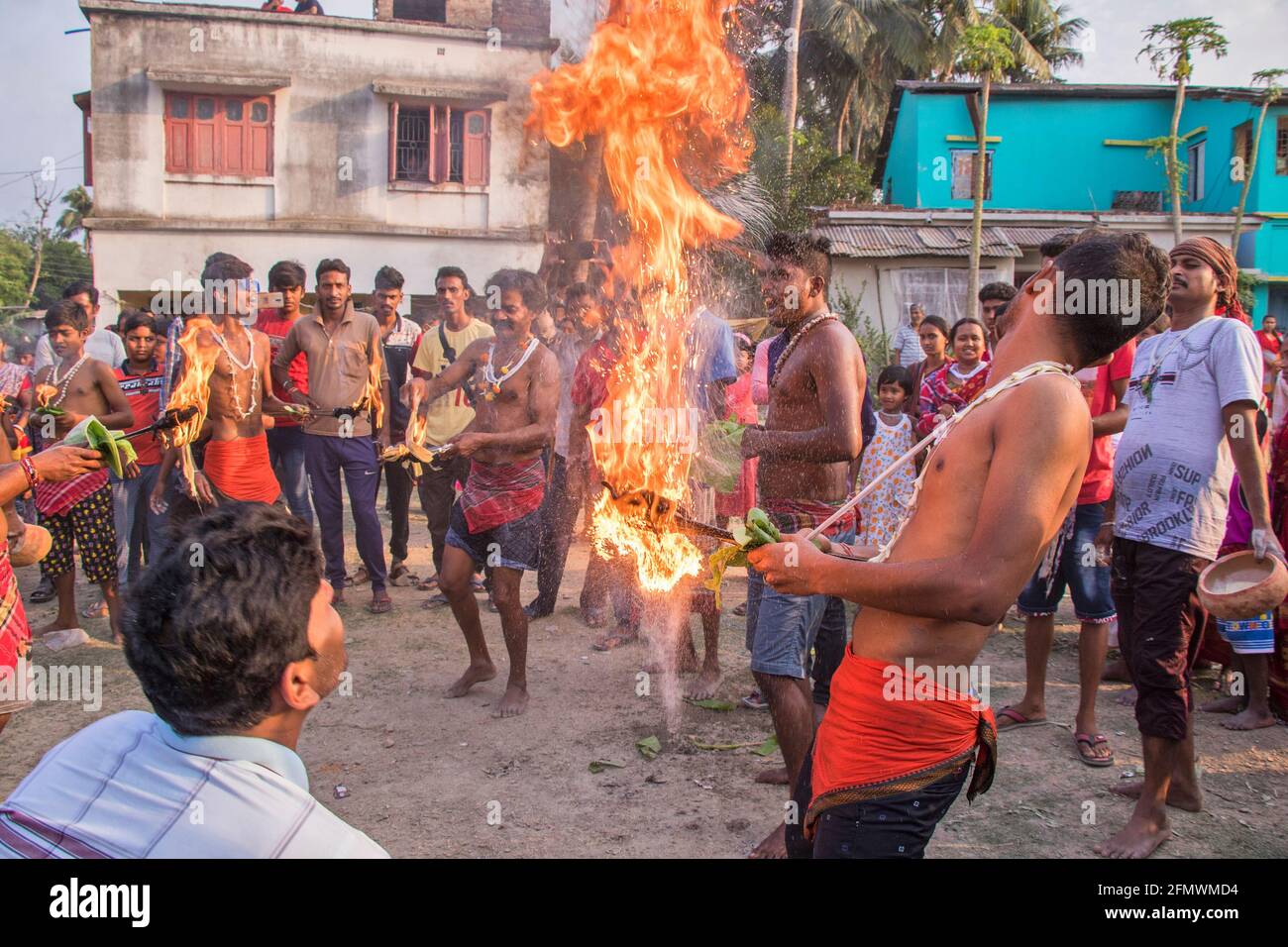 Gajan is a rural festival of Bengal.Here the devotees inserted sharp ...