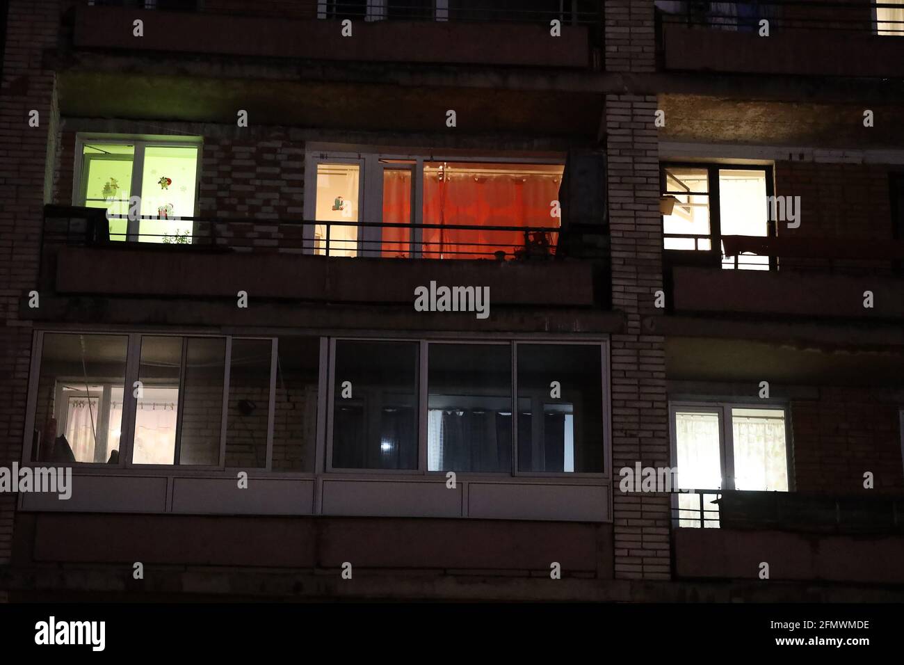 Windows glow in an apartment building at night. High quality photo ...