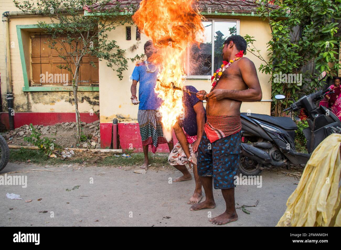 Gajan is a rural festival of Bengal.Here the devotees inserted sharp ...