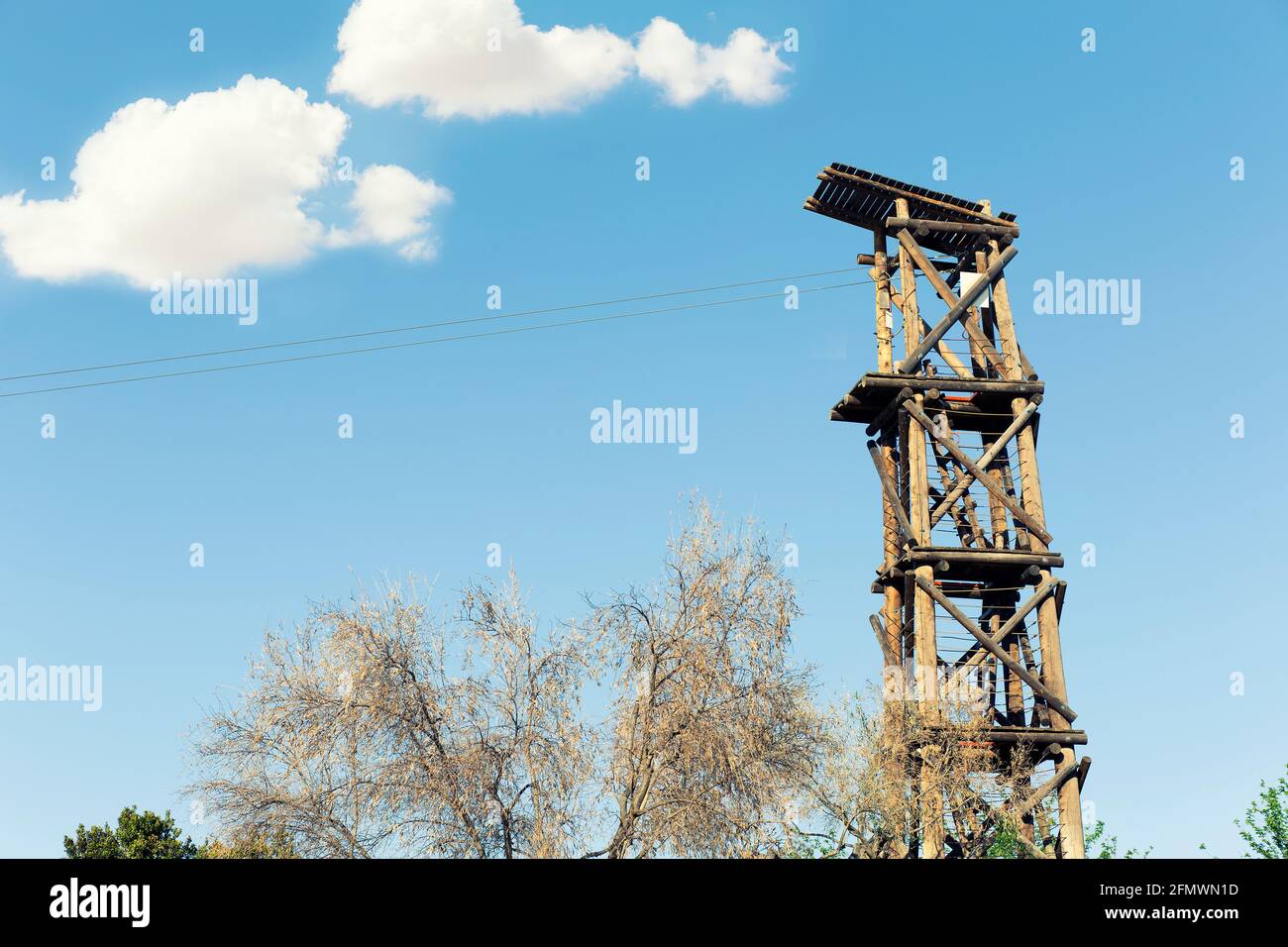 view of a platform on wooden tower to descend by cables Stock Photo - Alamy