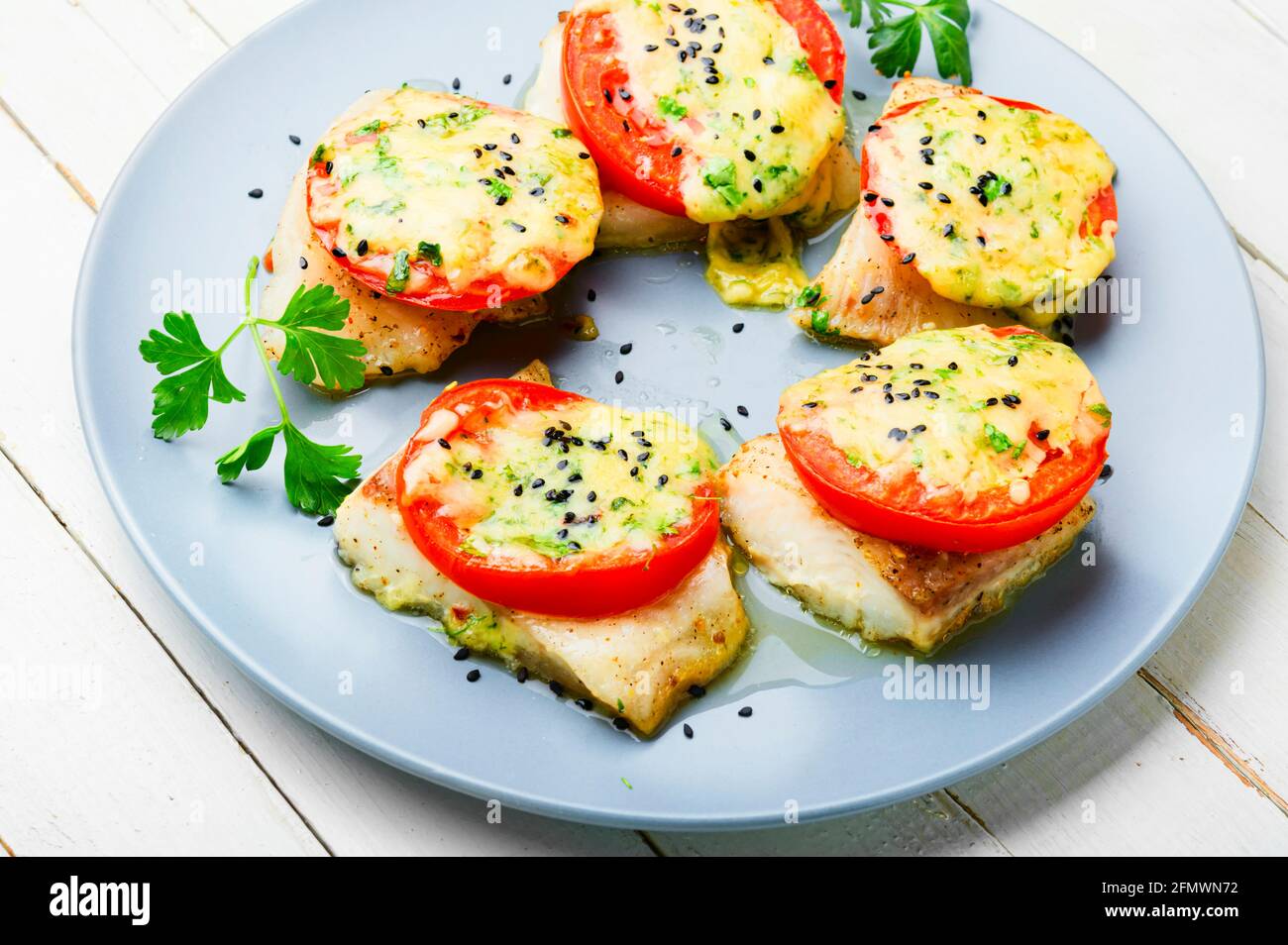Slice of fish baked with cheese,tomato and herbs.Roasted pangasius ...
