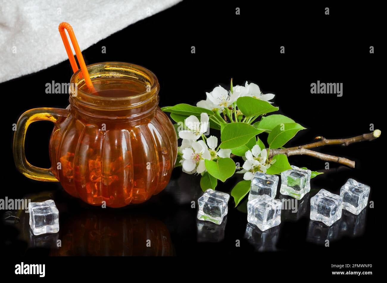 Iced tea with a straw in a jar, black background Stock Photo - Alamy