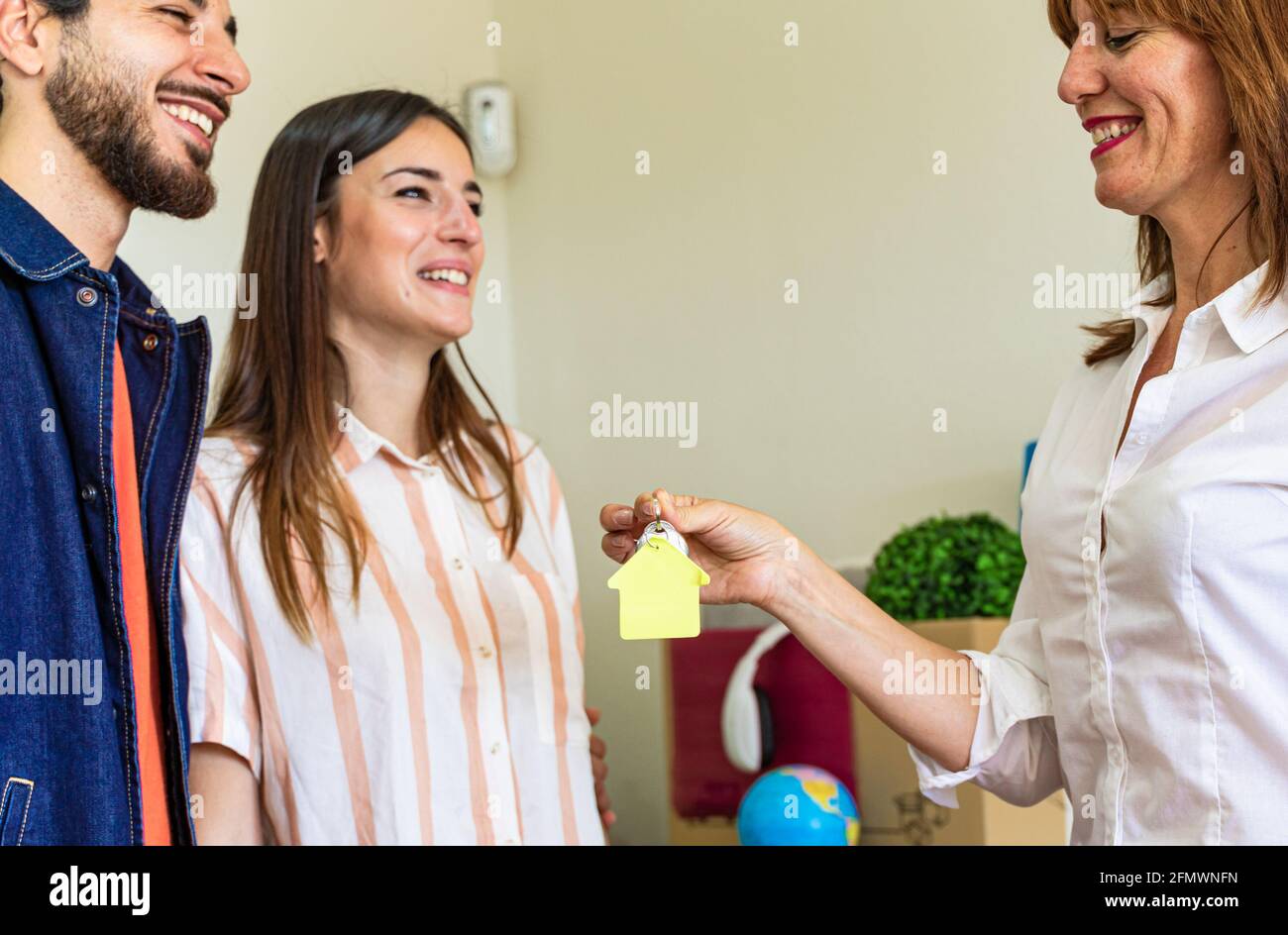Woman handing over key hi-res stock photography and images - Alamy