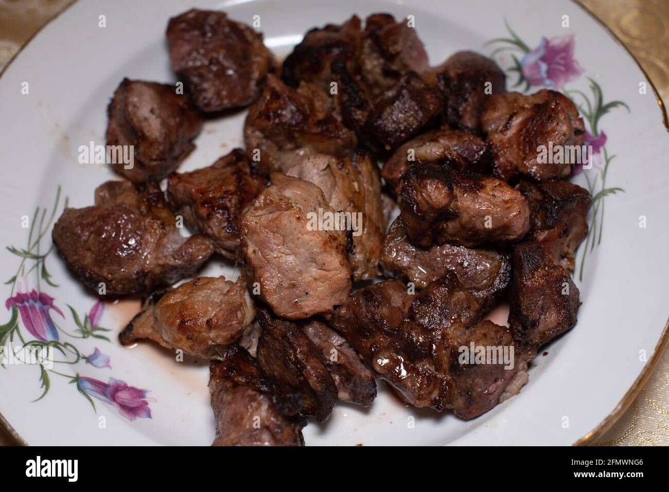 Fried pork kebab meat on a plate. Meat, food Stock Photo - Alamy