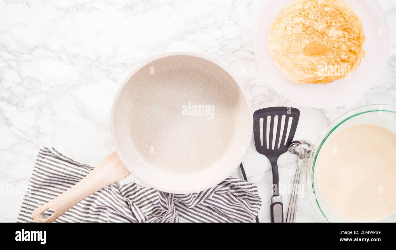 Flat lay. Making crepes in a small frying pan over medium heat Stock ...