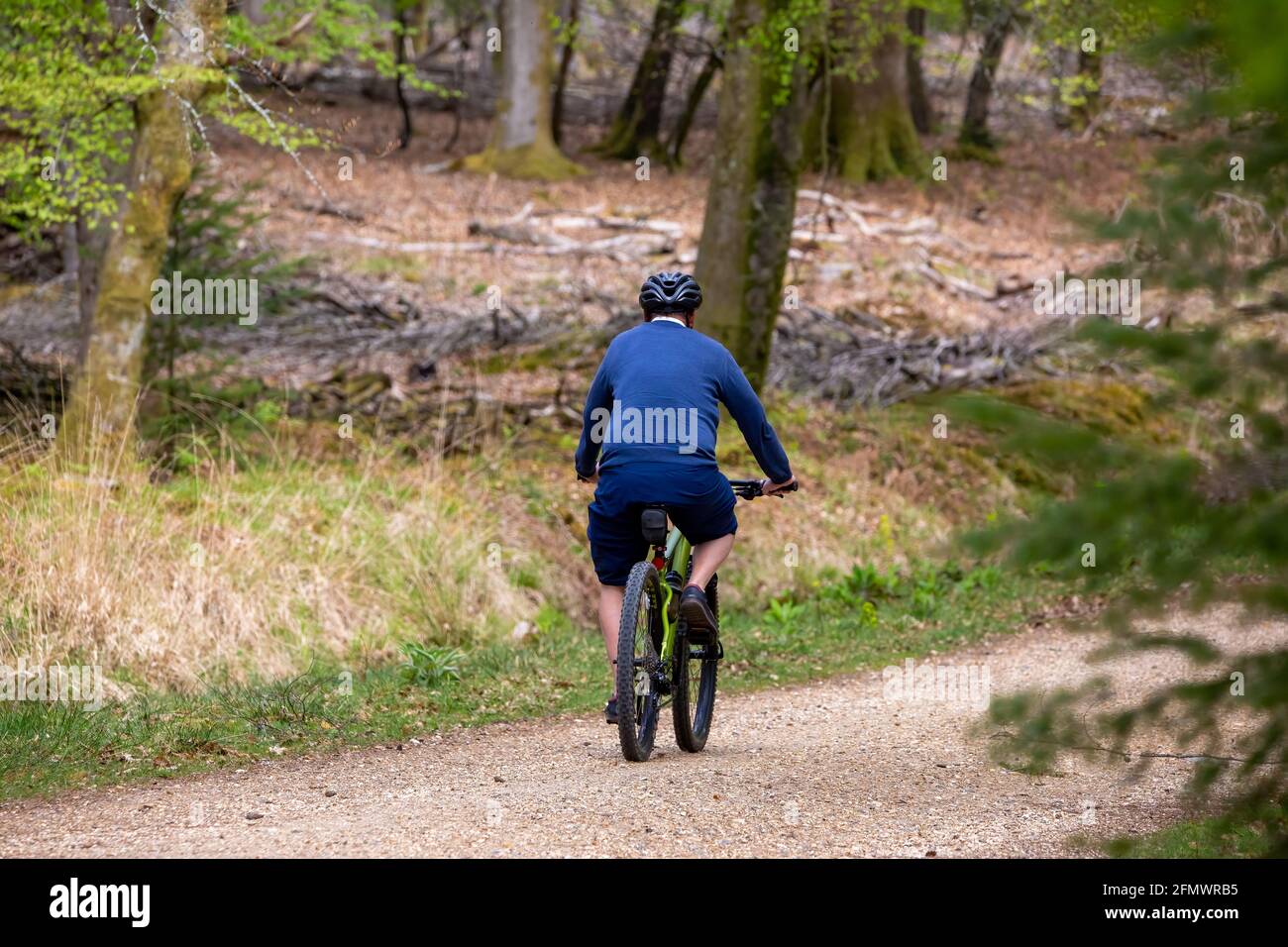 A Mad riding a mountain bike on a country track Stock Photo - Alamy