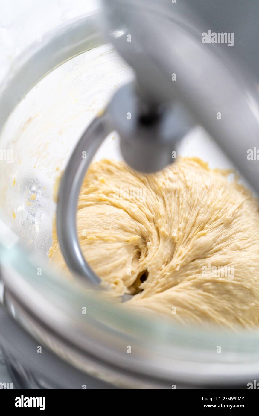 Mixing ingredients in kitchen mixer to bake homemade brioche buns Stock ...