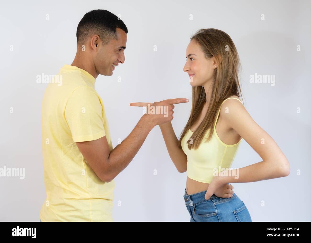 Young couple arguing over white background Stock Photo - Alamy