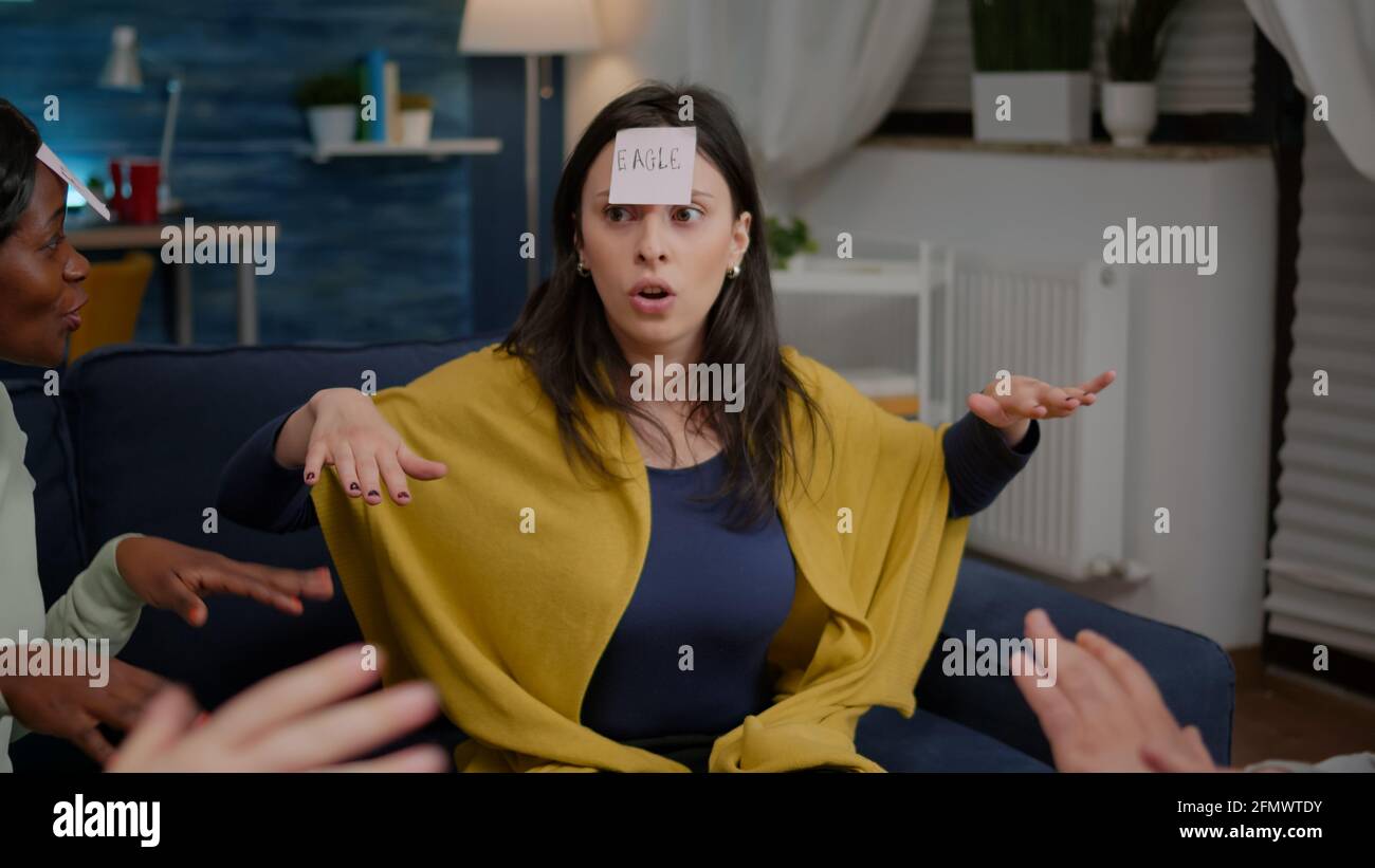 Multiethnic friends socializing while playing together funny sticky ...