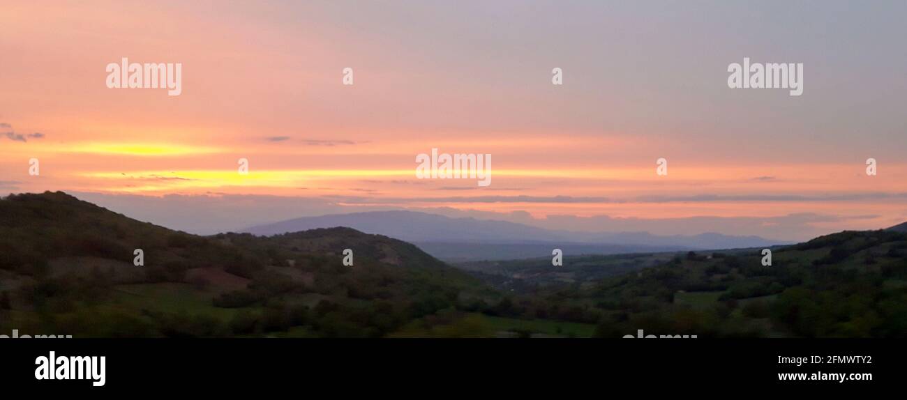 Sunset over hills wallpaper hi-res stock photography and images - Alamy