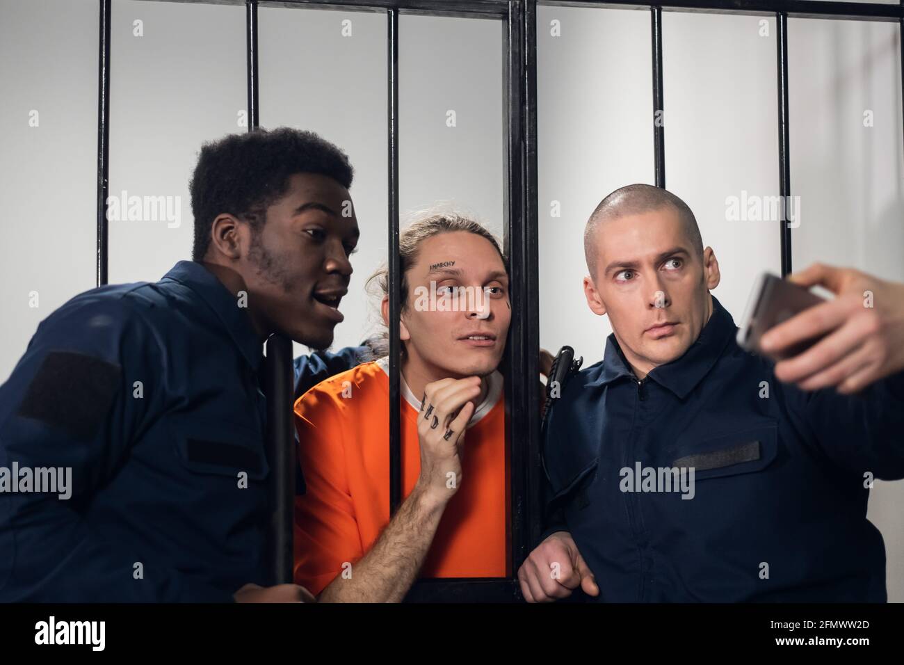 Wardens in a maximum security prison take selfies with a prisoner with ...