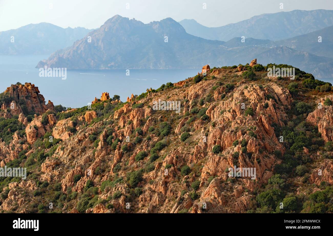 incredible red rocks in the wild environment called Calanques de Piana ...