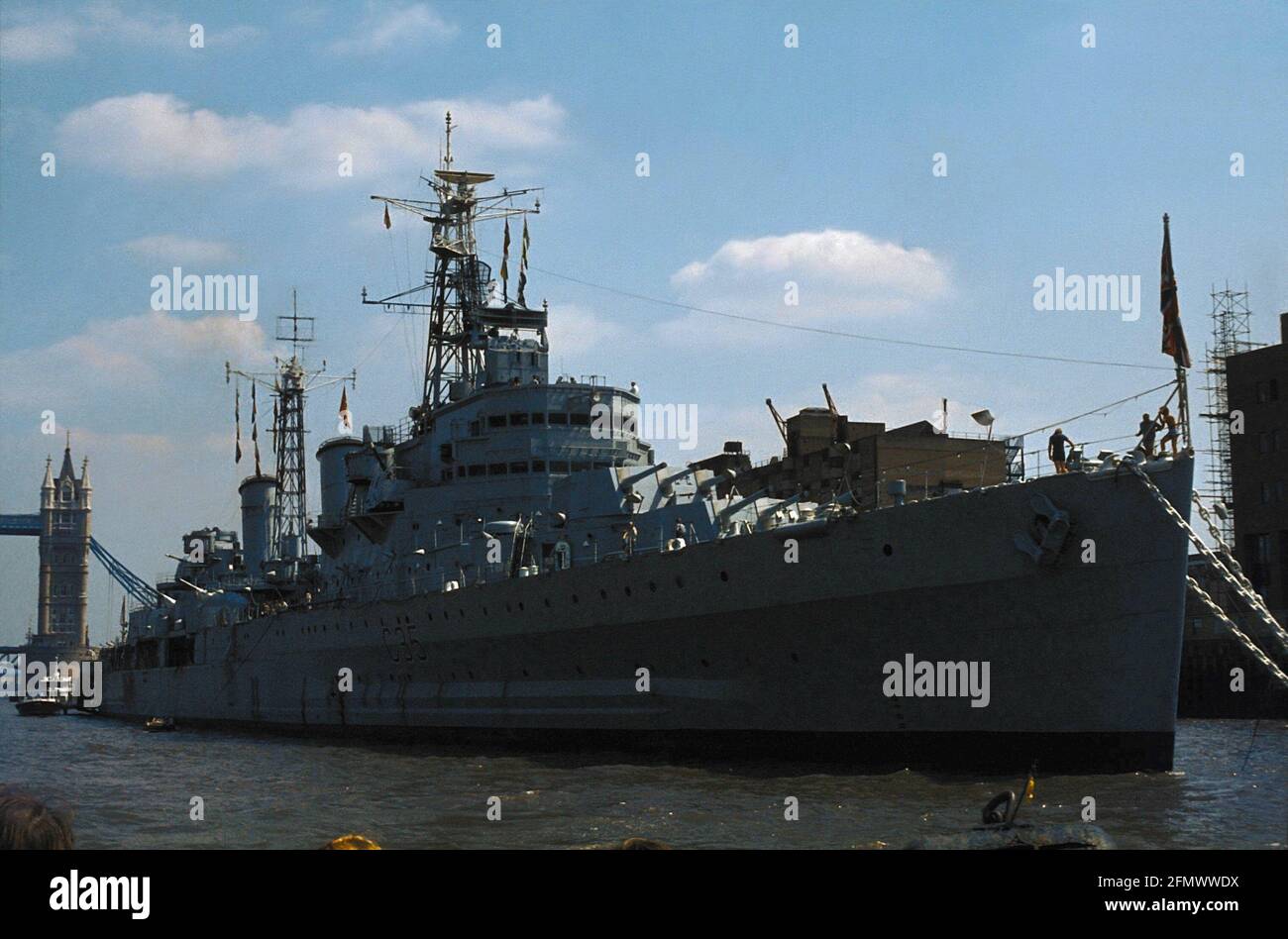 HMS Belfast warship moored on the Thames with part of Tower Bridge in ...