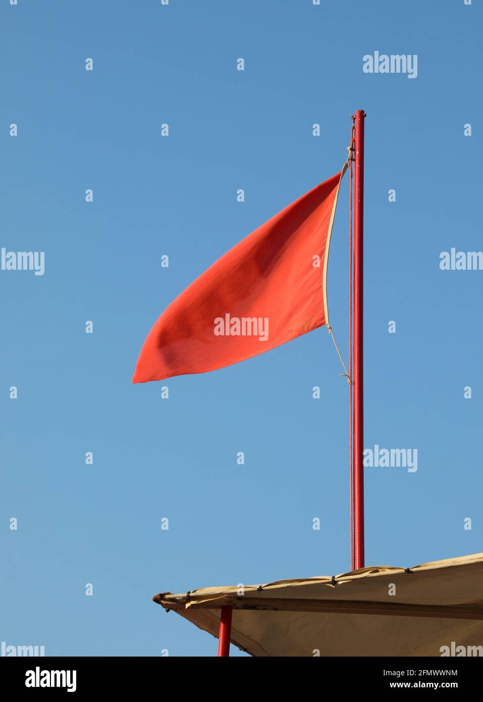 big red flag to signal the danger above the lookout tower Stock Photo ...