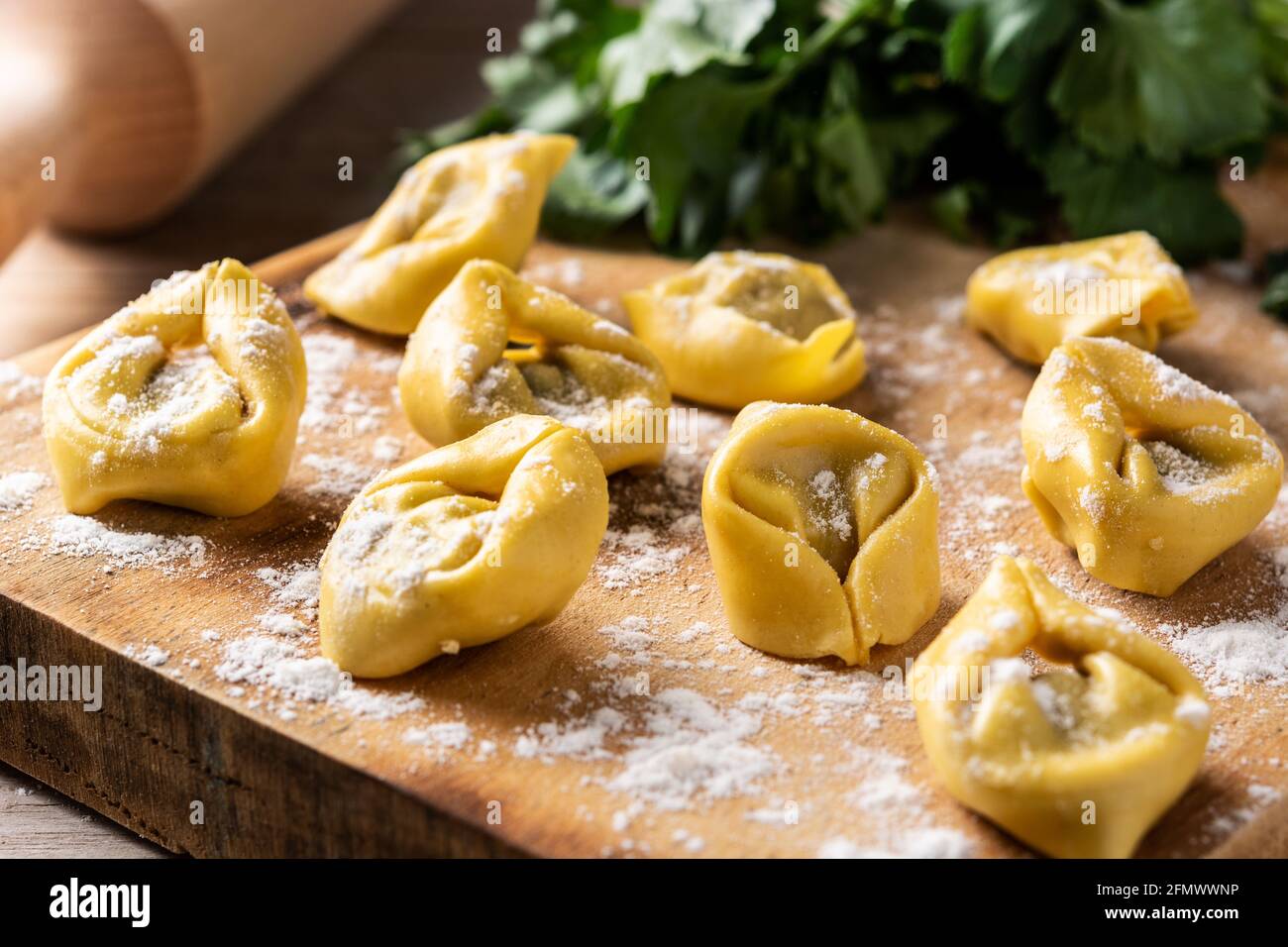 Uncooked pelmeni dumplings on rustic wooden table. typical russian food ...