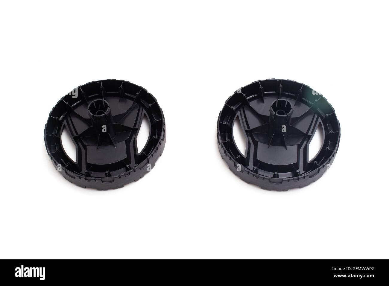 Black plastic wheels from a pressure washer on a white background ...