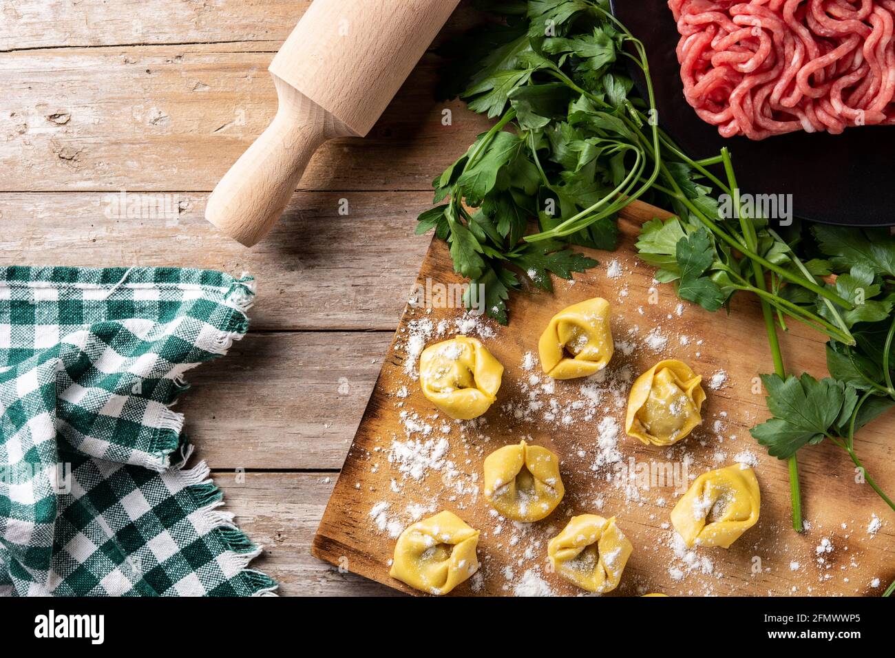 Uncooked pelmeni dumplings on rustic wooden table. typical russian food ...