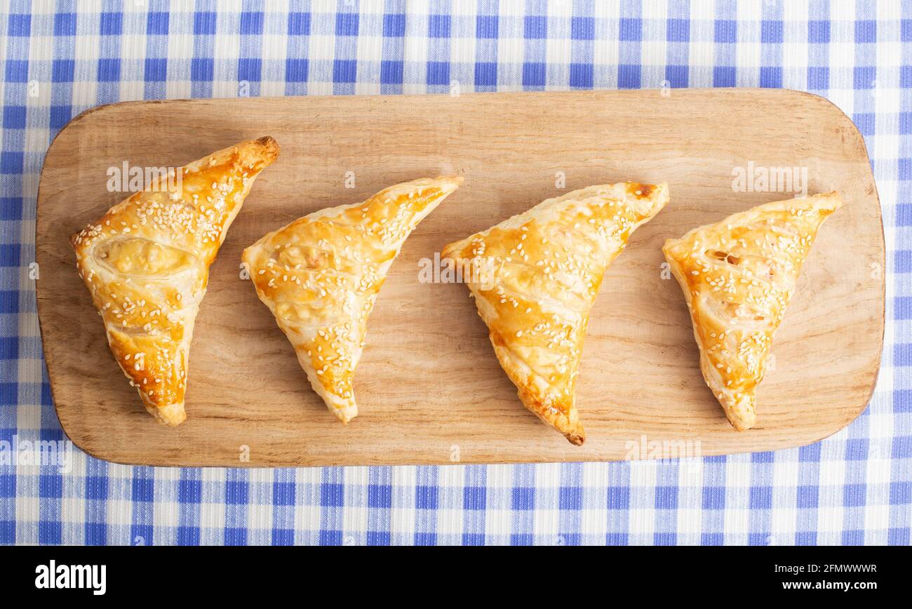 Delicious crunchy puffs with ham and cheese on a checkered background ...