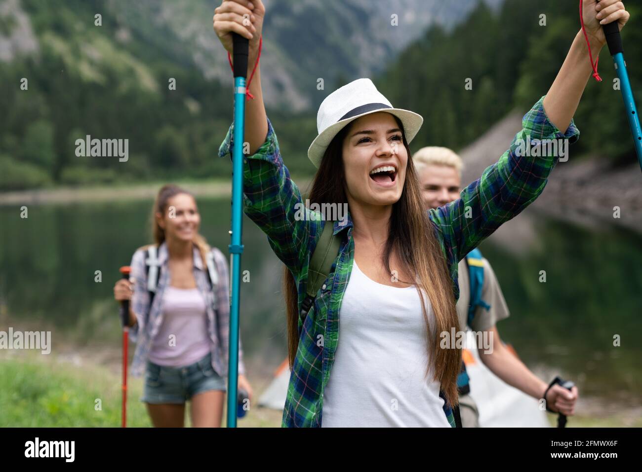 Group of fit healthy friends trekking in the mountains Stock Photo - Alamy