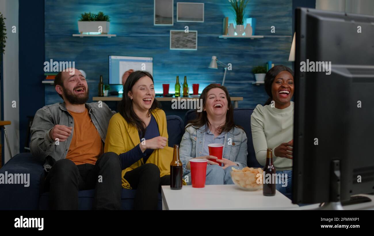 Multiracial friends laughing smiling having fun together while sitting ...