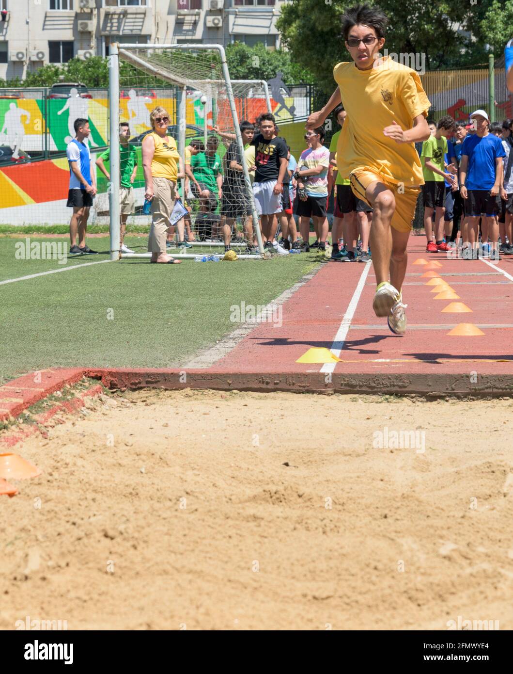 High school student competes in the school long jump event of the track ...
