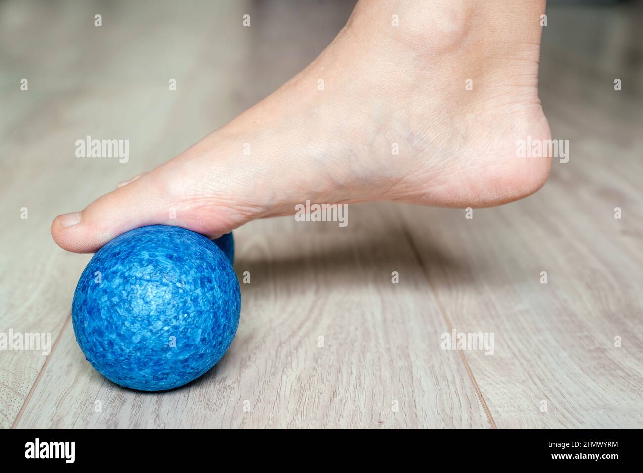 Foot steps on the trigger point massage peanut ball to relieve Plantar ...