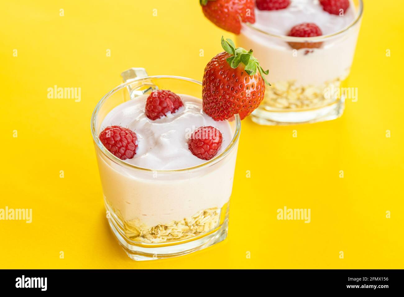Delicious strawberry and raspberry yogurt on a yellow background Stock ...
