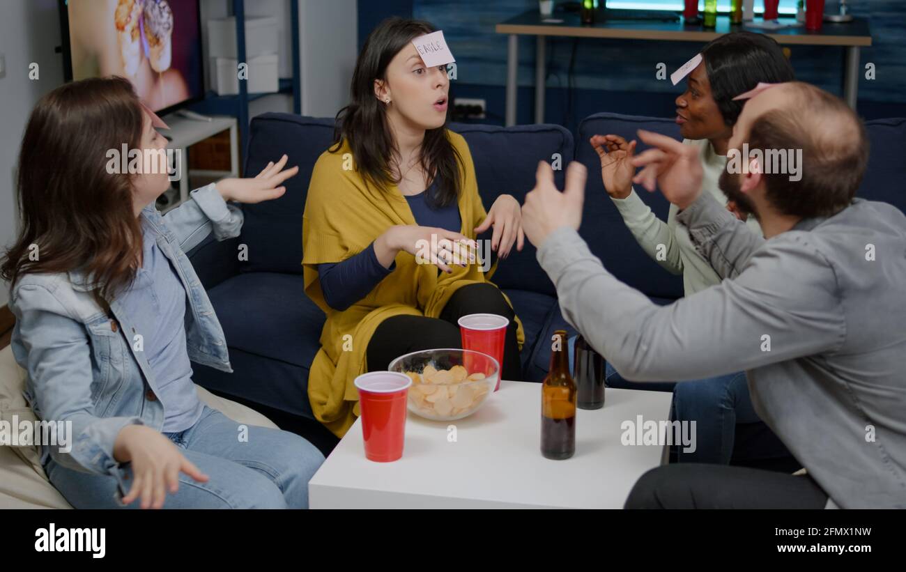 Group of mixed race people enjoying time together while playing ...
