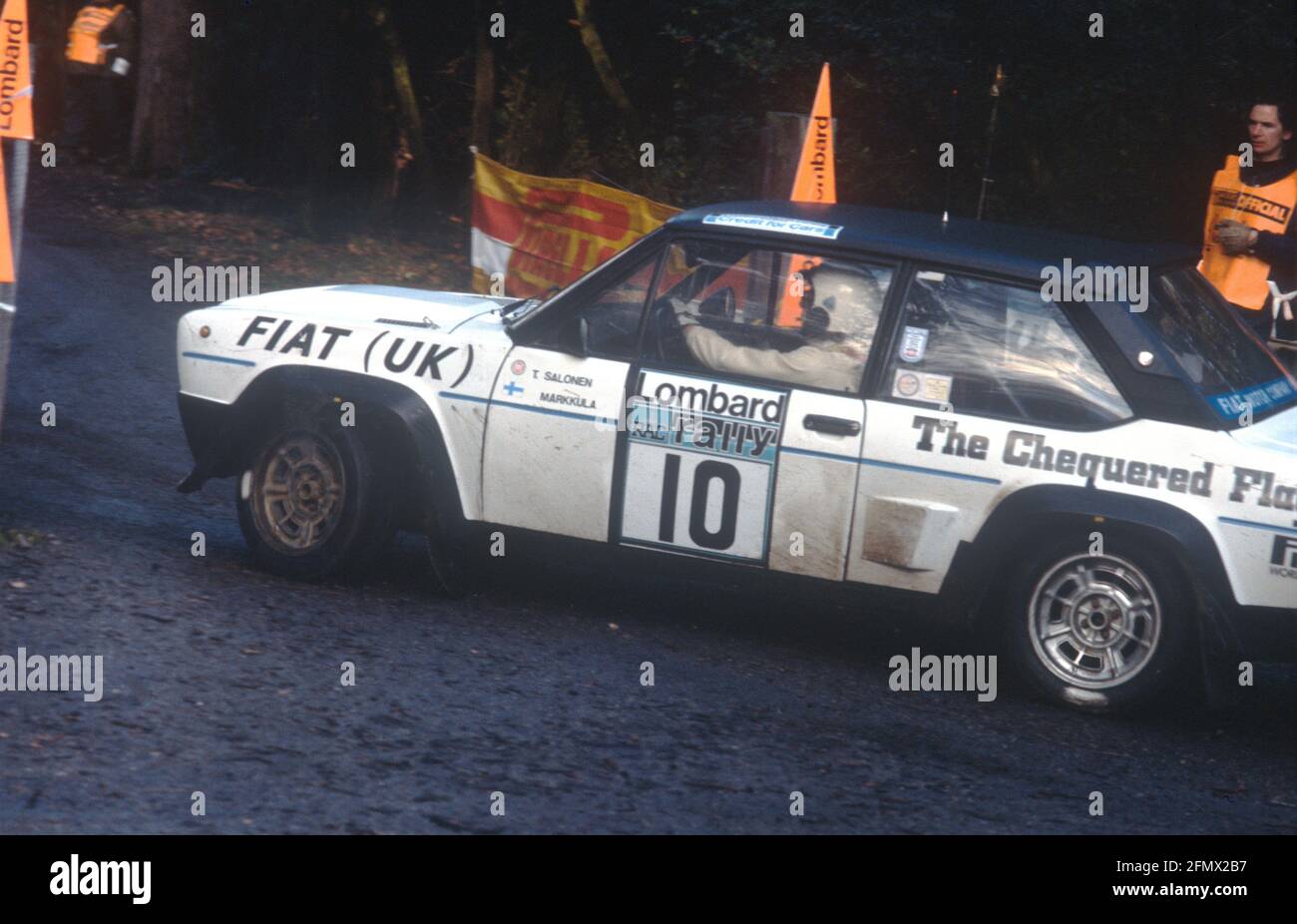 Timo Salonen slots his Fiat 131 Abarth through a narrow gateway on the ...