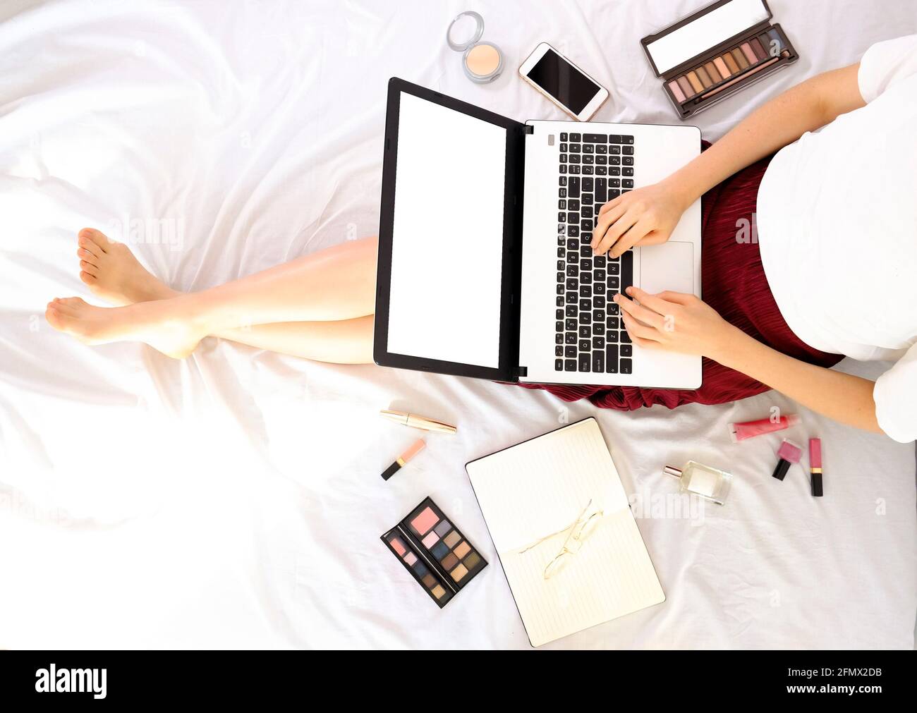 Young woman fashion beauty blogger using her laptop while sitting on ...