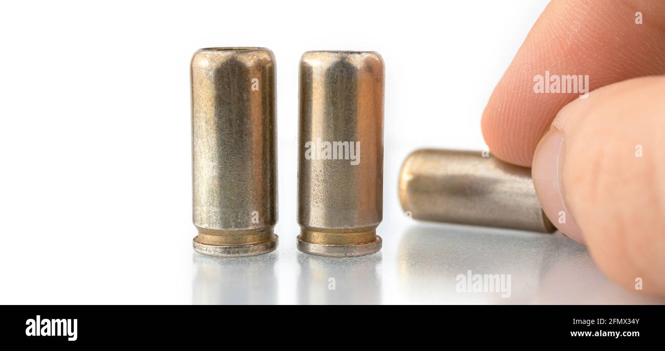 Banner 9mm bullets on white background with the hand Stock Photo - Alamy