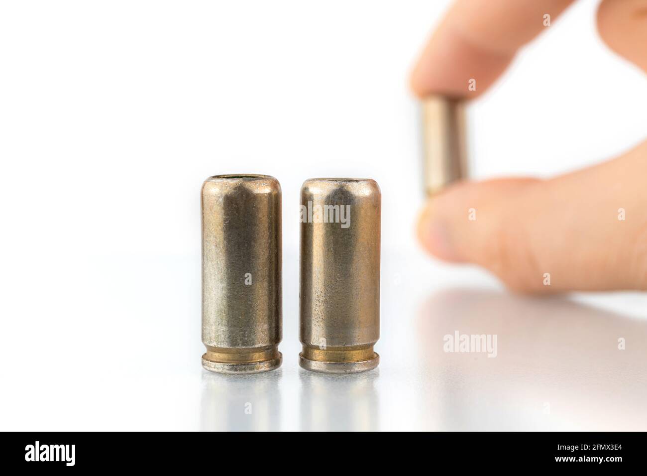 9mm bullets isolated on a white background, hand with bullet shell ...