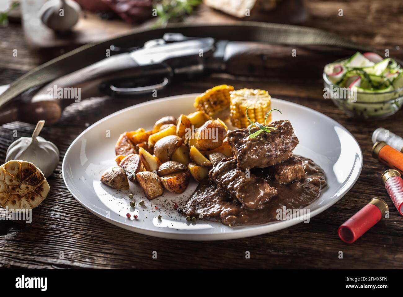 Wild game goulash stew served with roasted potatoes and seasoned with ...
