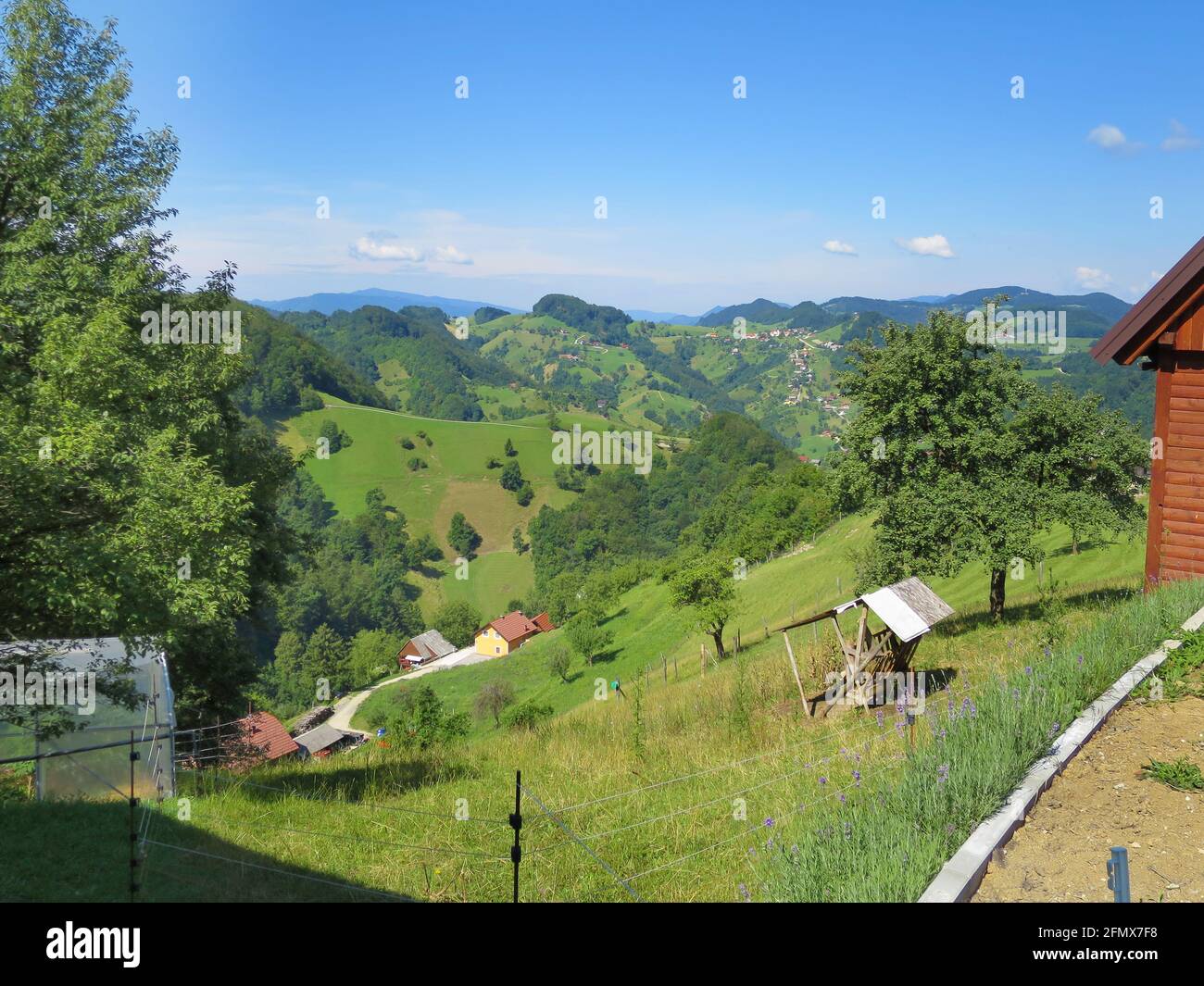 Beautiful landscape with small rural houses on the blue sky background ...
