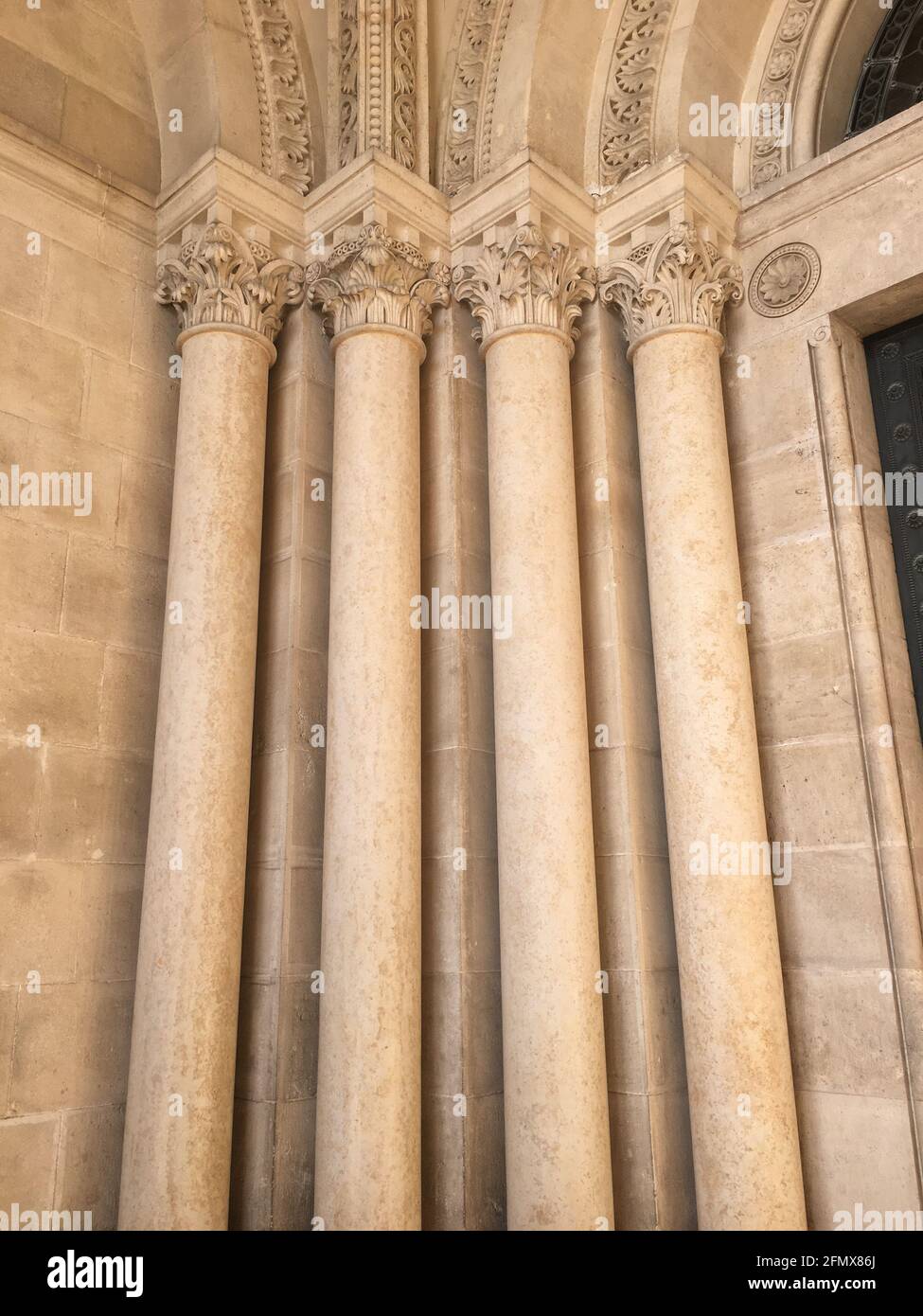 Vertical shot of a building high columns with fine work on the stone ...