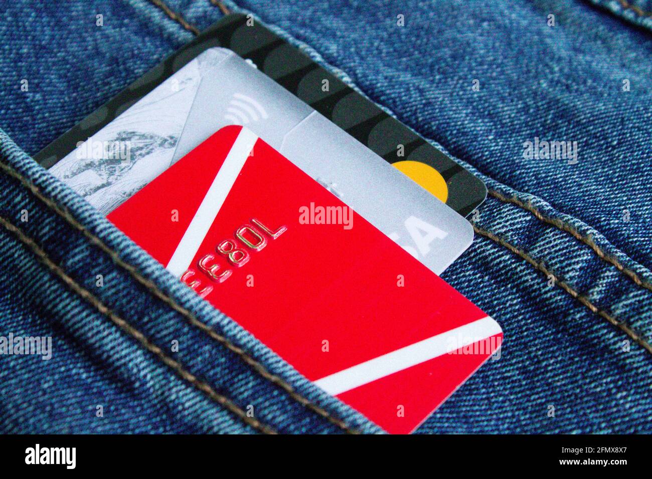 Plastic cards in your pants pocket. Cards for payment in jeans. Multi ...