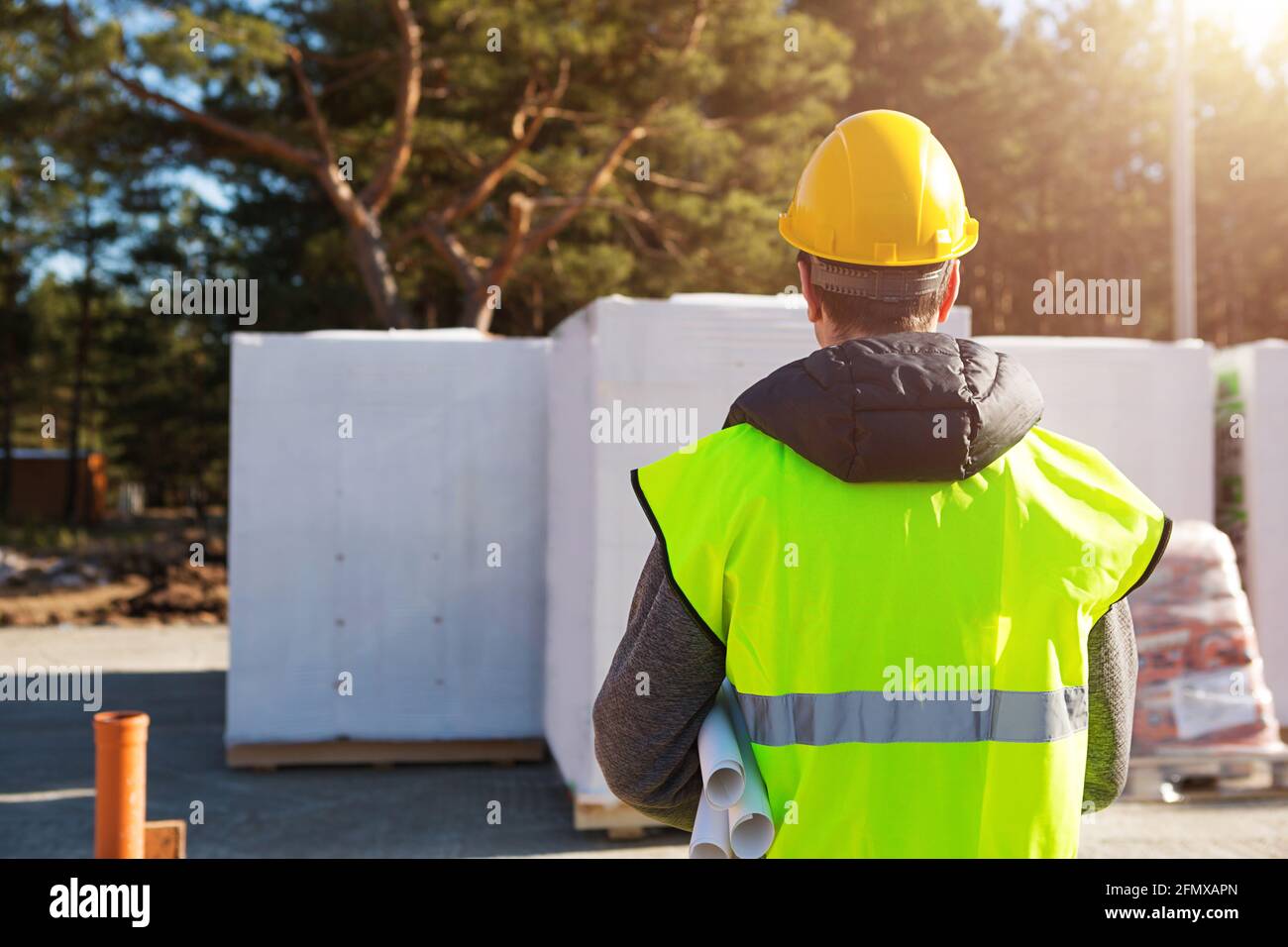 The project architect's back is on the construction site of a house ...