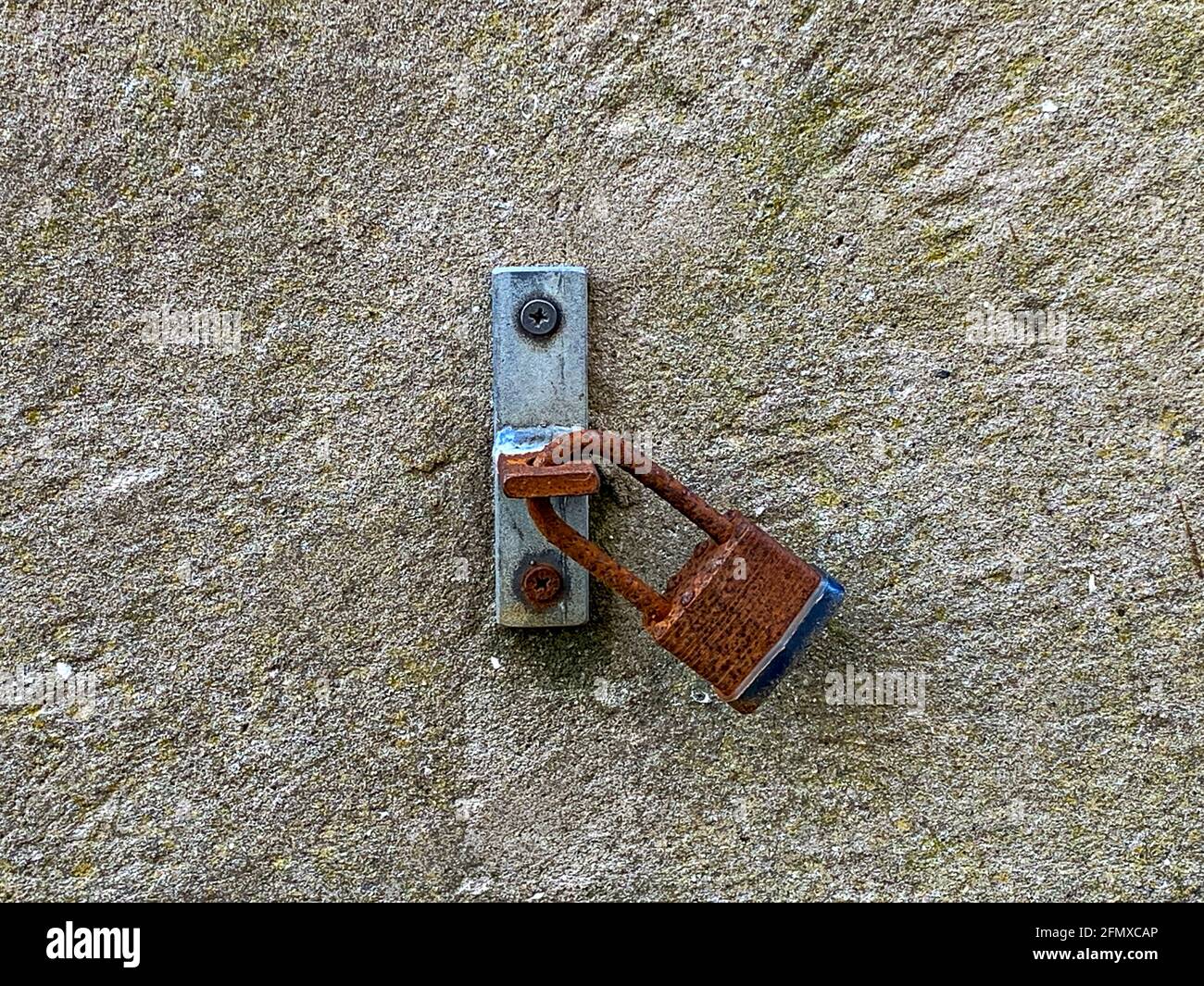 Rusted padlock hanging from bolt on exterior wall Stock Photo - Alamy