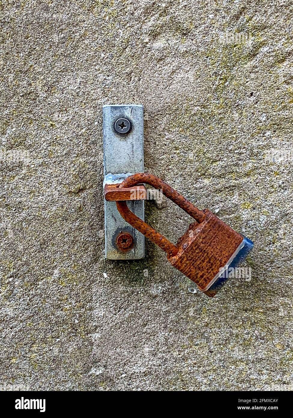 Rusted padlock hanging from bolt on exterior wall Stock Photo - Alamy