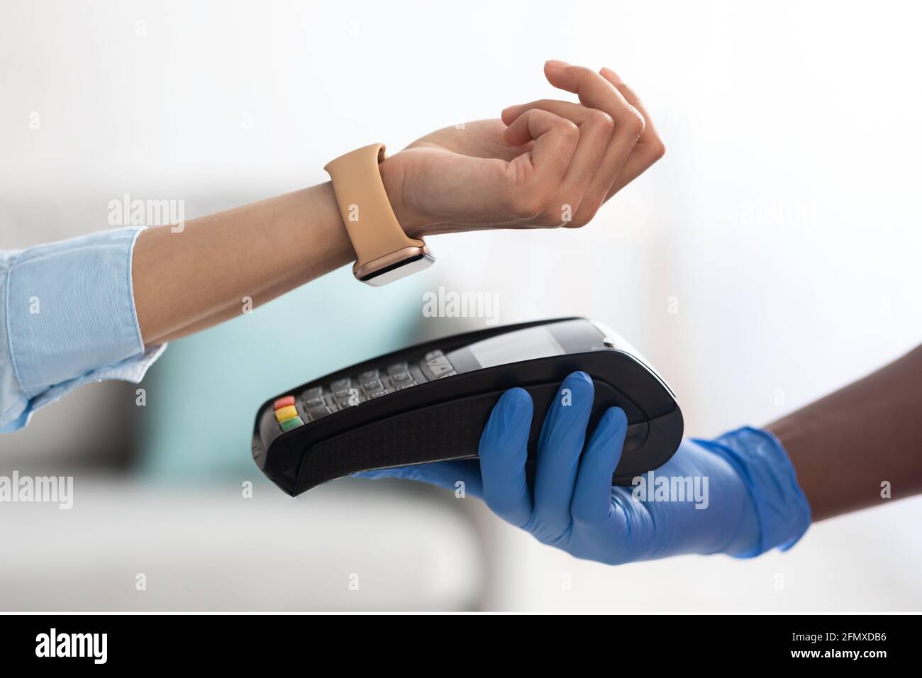 Black man holding POS machine client paying with smart watch Stock ...