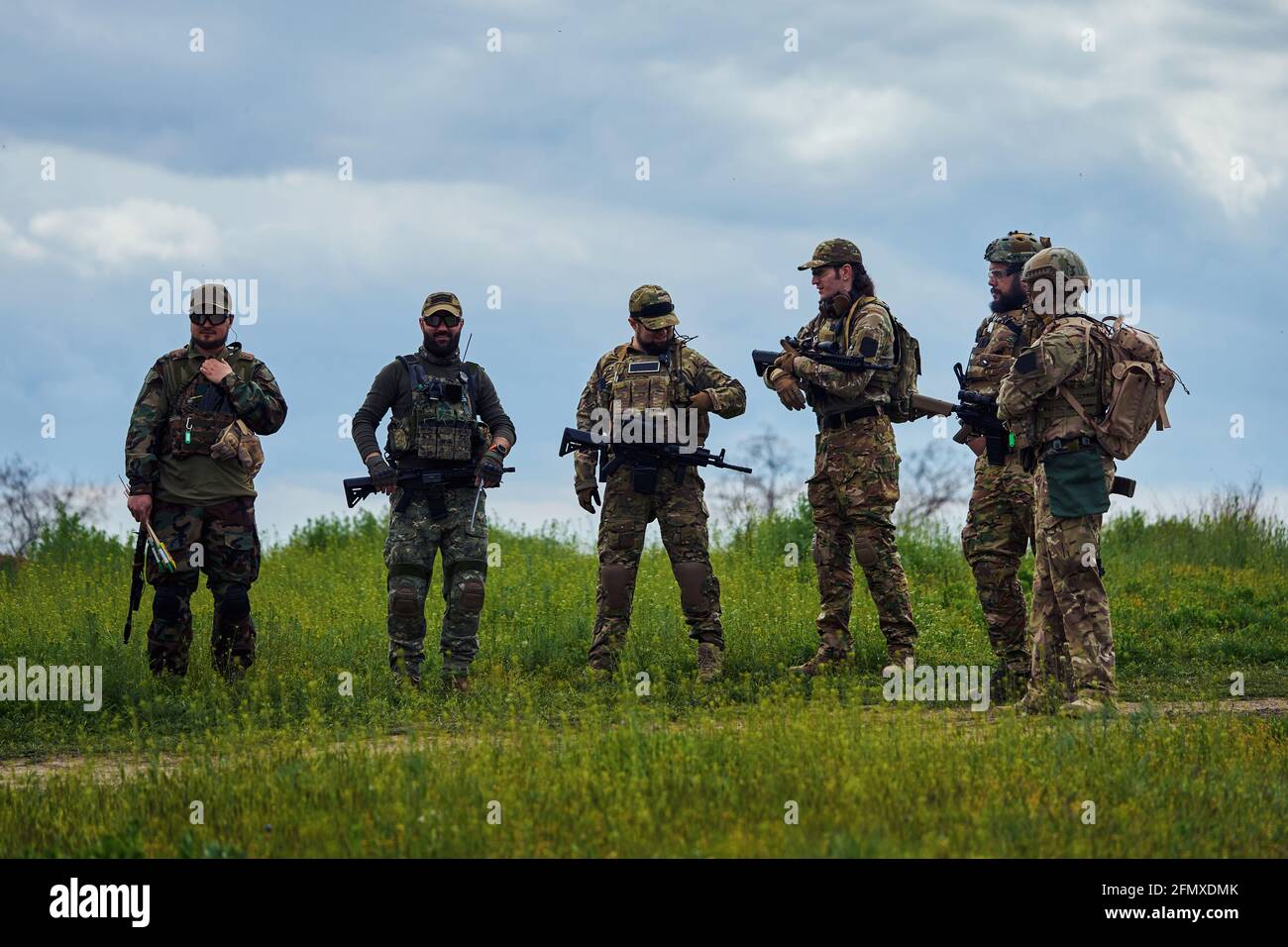 A group of airsoft players in outfit with a weapon in their hands Stock ...