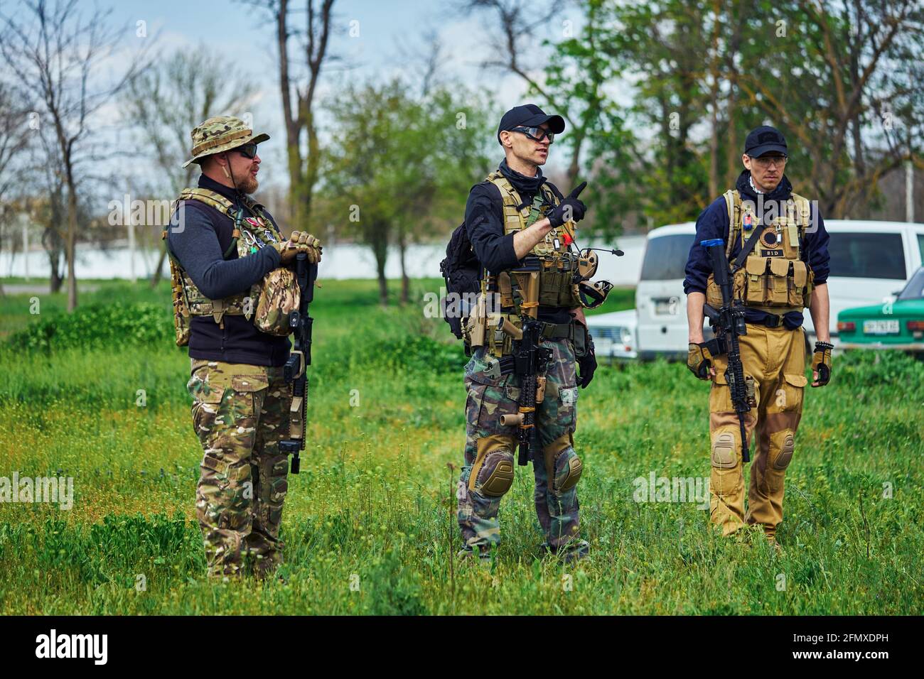 A group of airsoft players in uniform with weapons before the start of ...